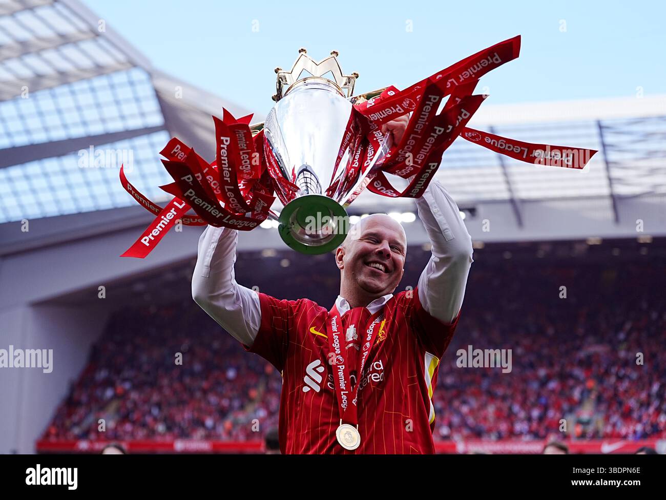 Liverpool manager Arne Slot celebrates with the Premier League trophy ...