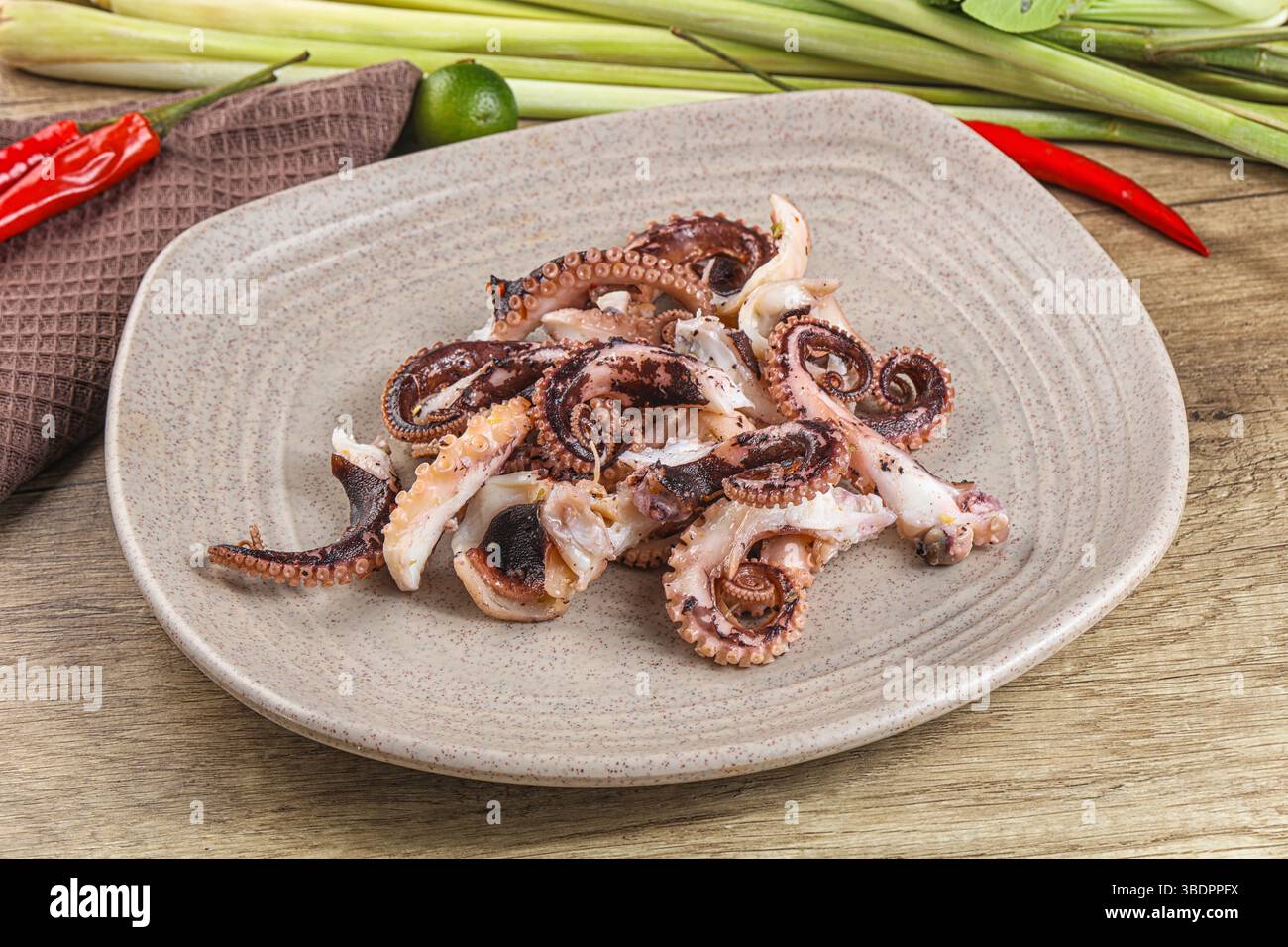 Grilled octopus red tentacle sliced appetizer Stock Photo - Alamy