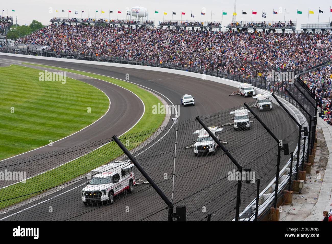 Track-drying trucks work on the track during a rain delay before the ...