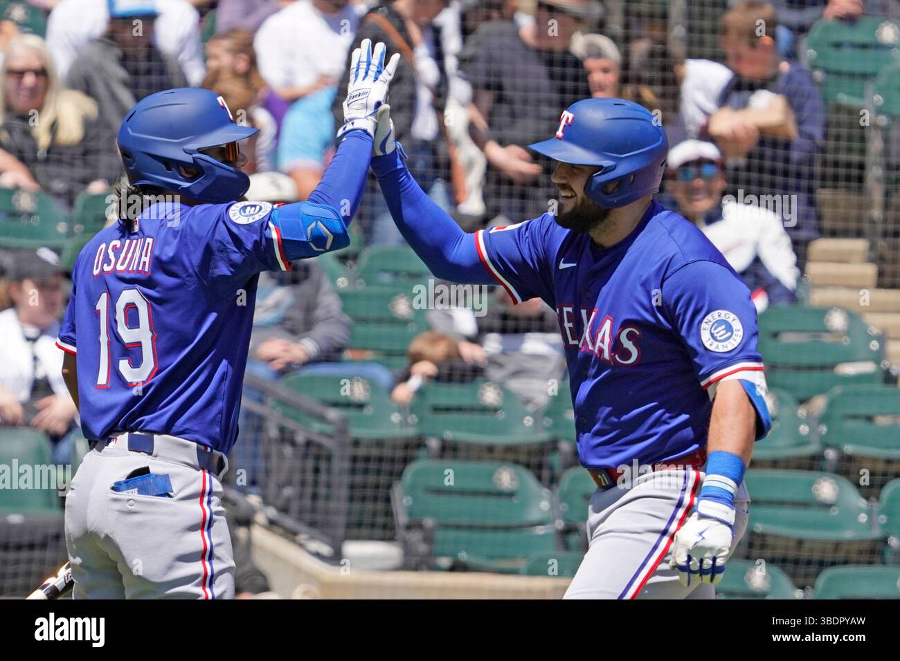 Texas Rangers' Jake Burger, right, is greeted by Alejandro Osuna, left ...