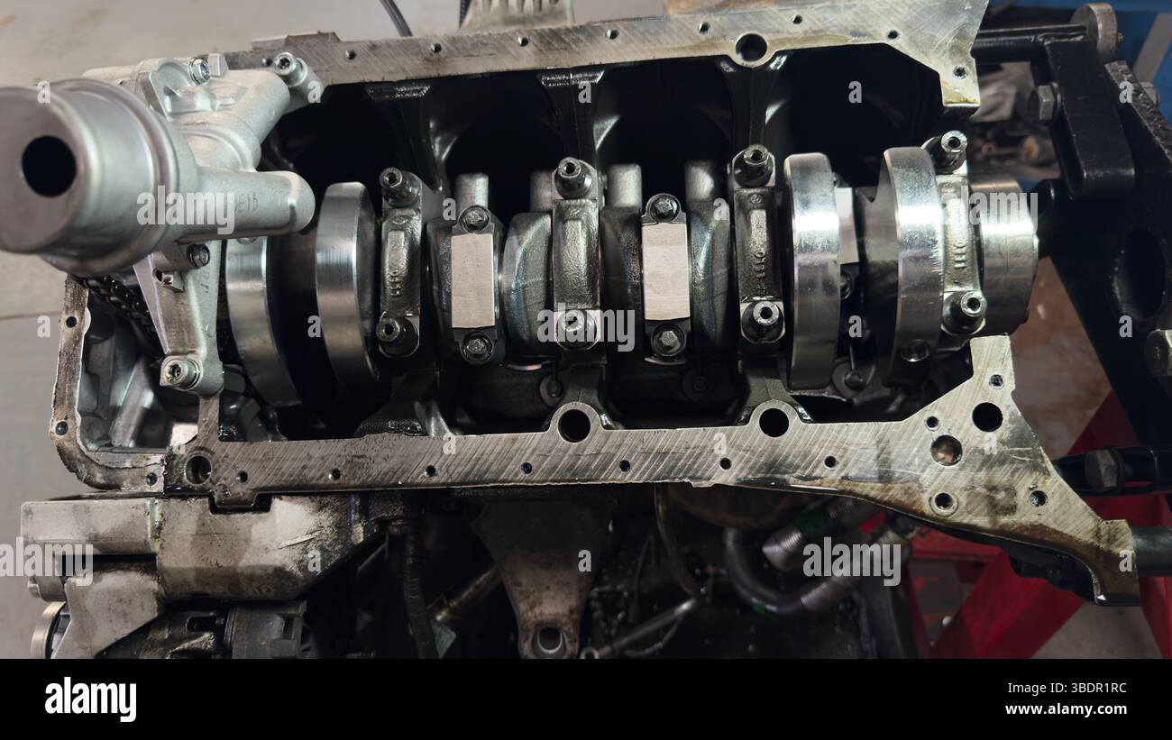 Exposed internal parts of a car engine showing crankshaft and ...