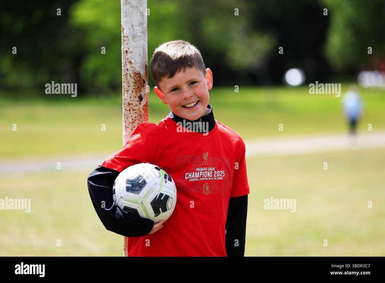 Liverpool, UK. 25th May, 2025. A young fan poses for a photo outside ...