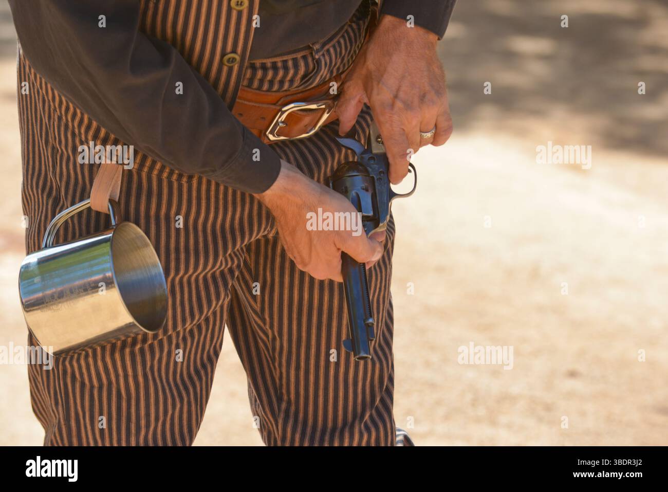 Cowboy reenactor reloading his colt 45 on the streets of Tombstone ...