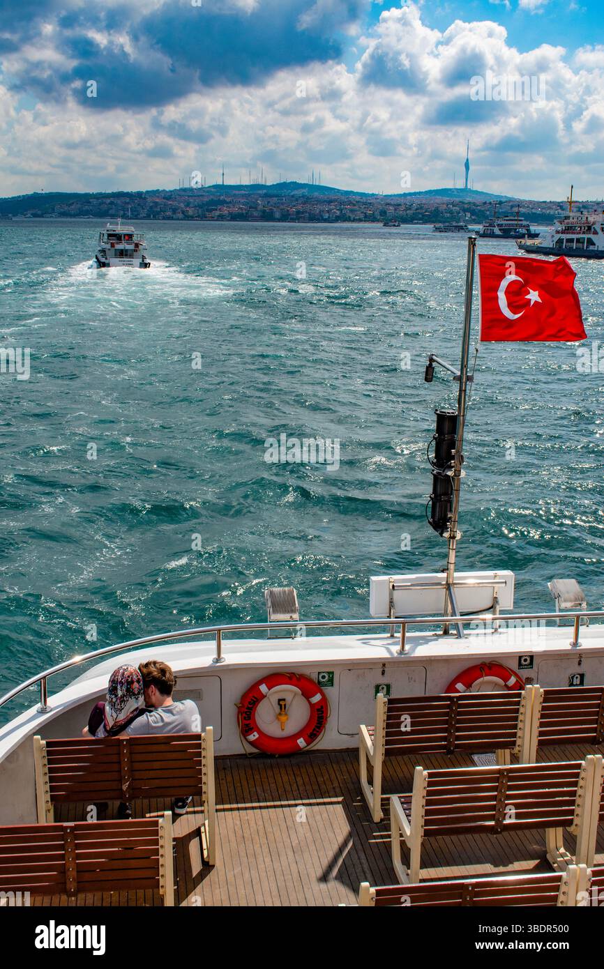 Istanbul, Turkey: a young couple in love embracing on the ferry boat ...
