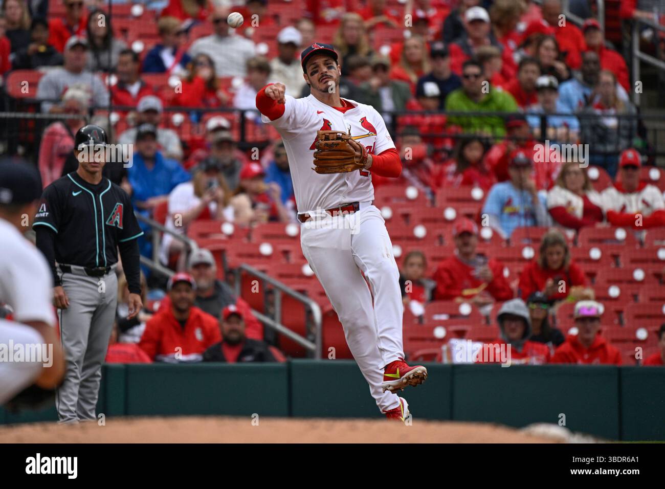 St. Louis Cardinals third baseman Nolan Arenado, right, throws out ...