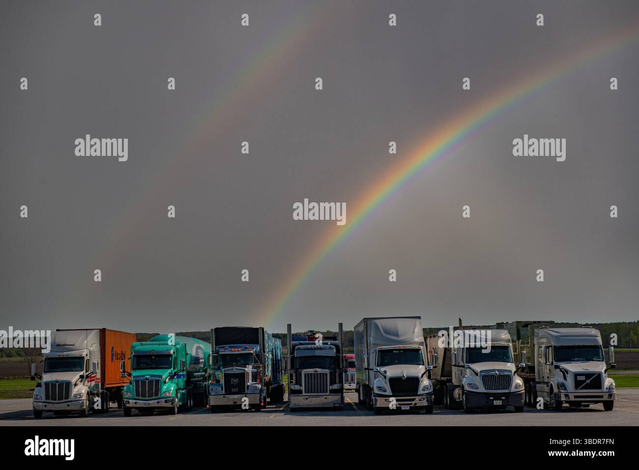 Freight lorries under a rainbow in North America Stock Photo - Alamy