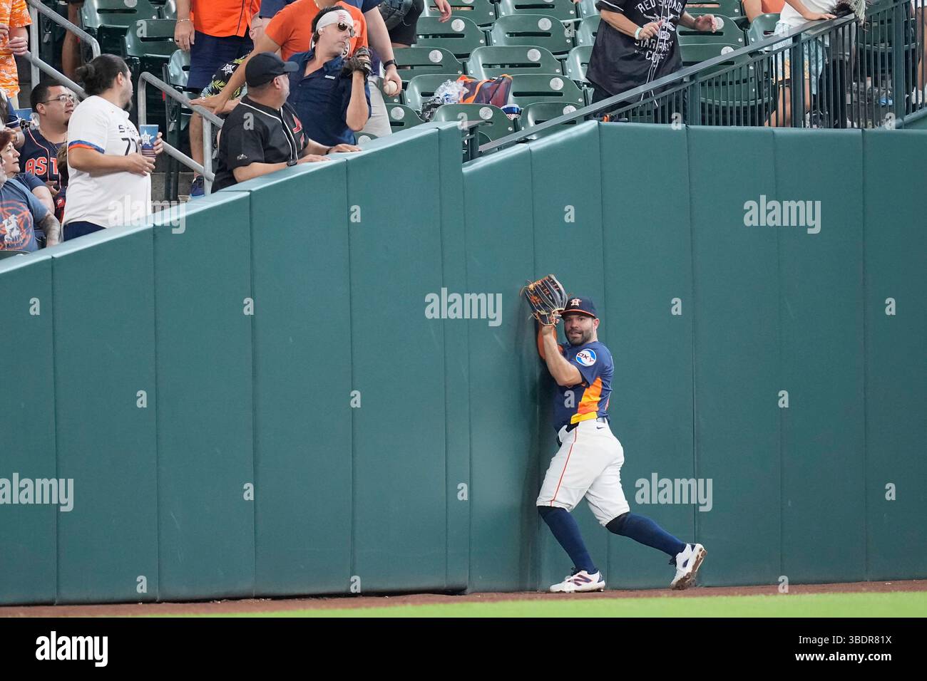 Houston Astros left fielder Jose Altuve catches a fly ball in foul ...