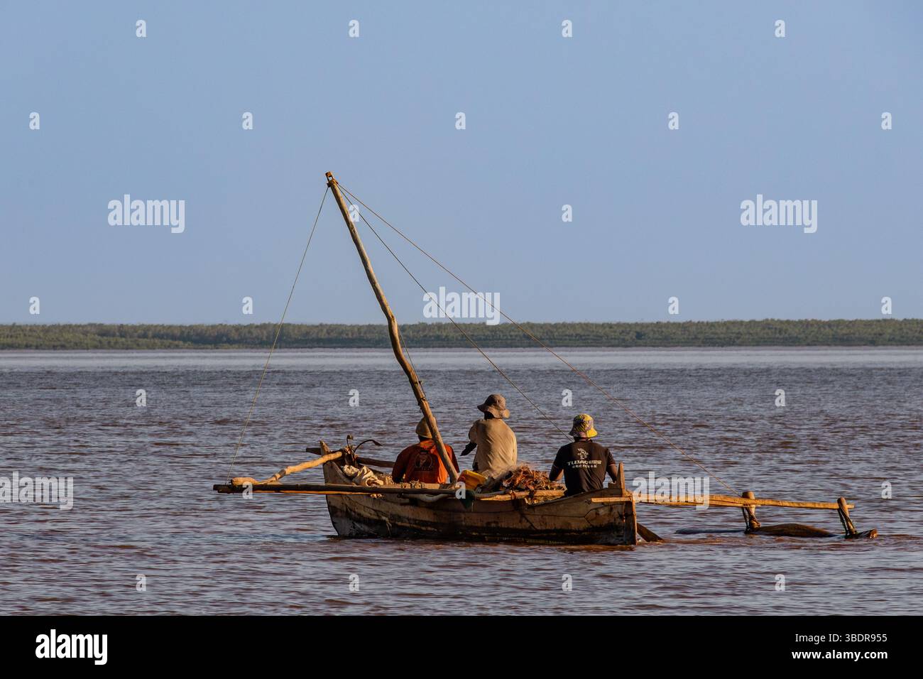 Madagascar Three fishermen on a boat Stock Photo - Alamy