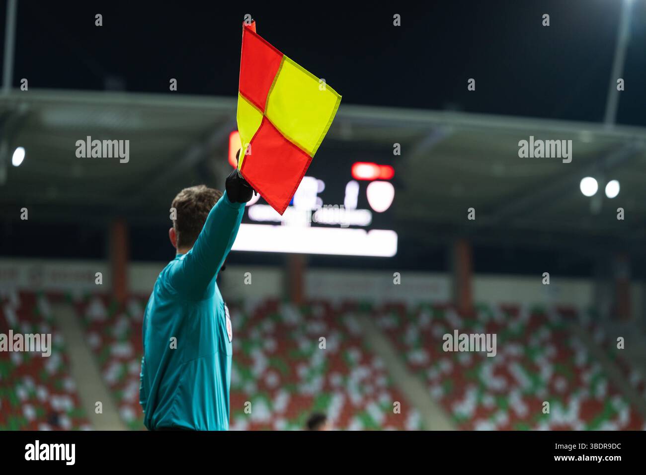 Soccer touchline referee with the flag during match at the football ...
