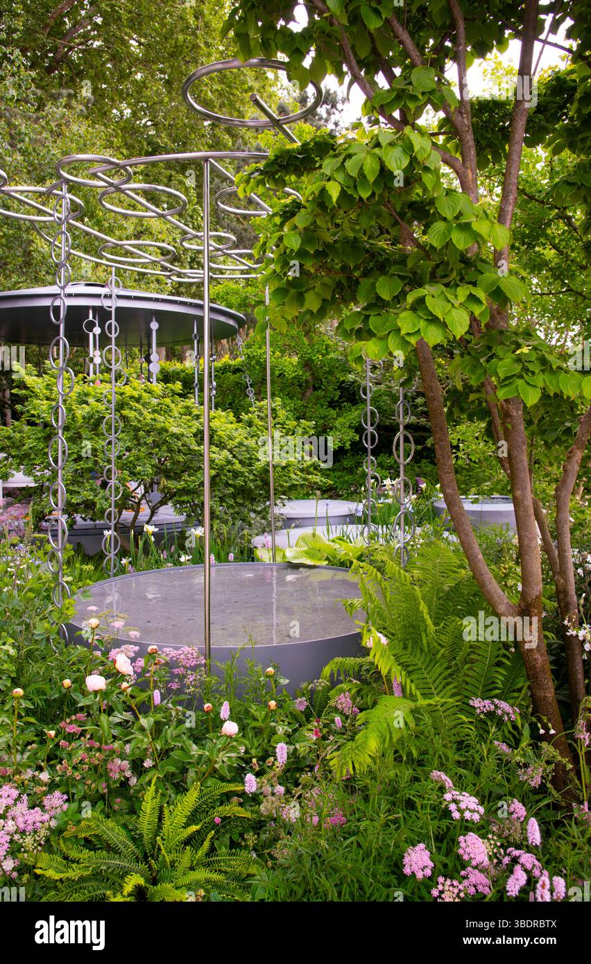 Planting around a circular pavilion and pools surrounded by lush ...