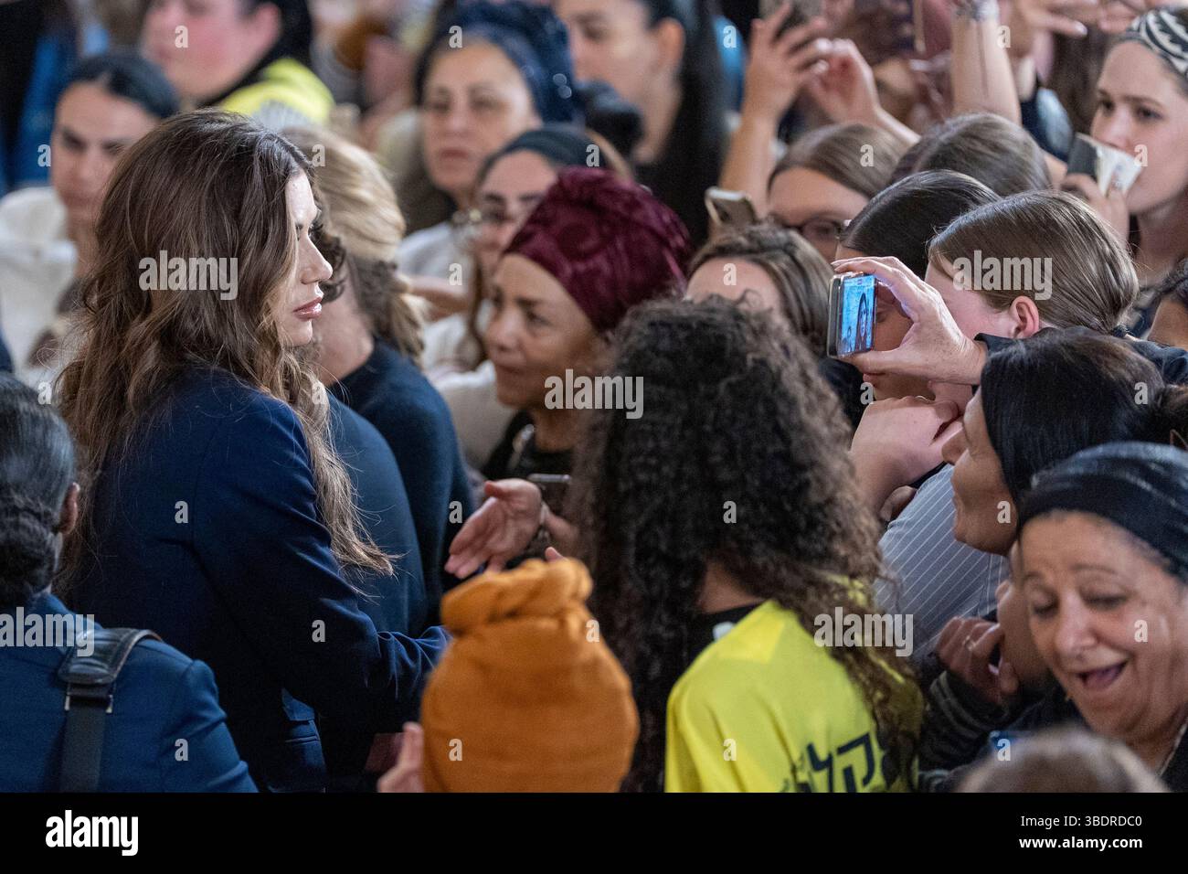 Homeland Security Secretary Kristi Noem greets people after placing a ...