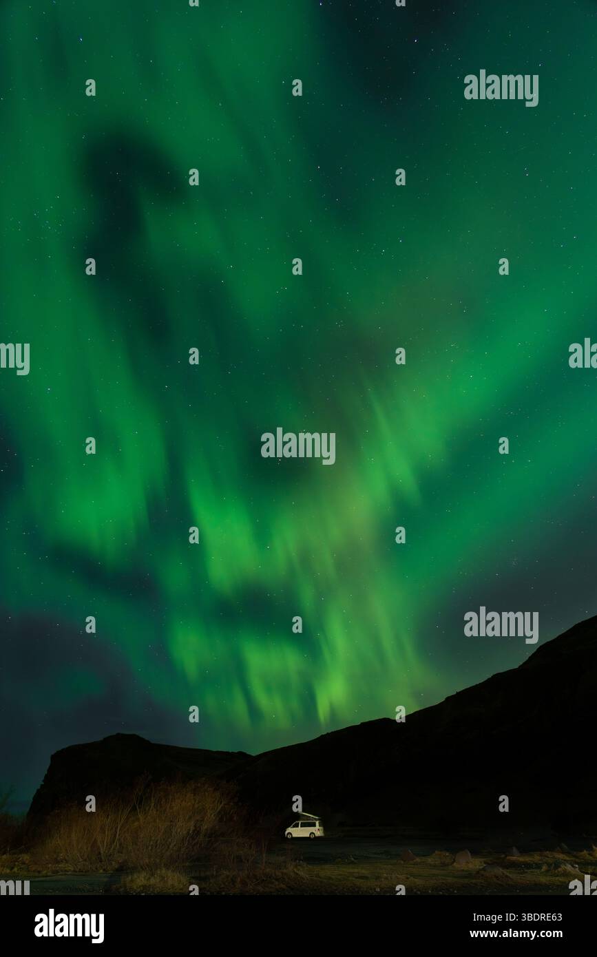 Green Northern Lights over Icelandic Mountains at Night with Starry Sky ...