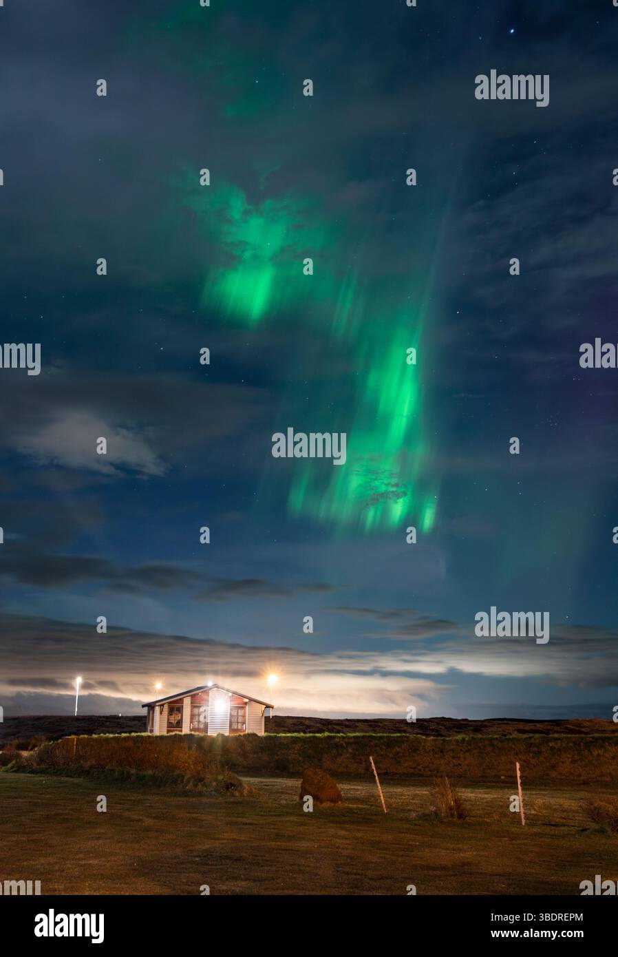 Green Northern Lights over Icelandic Mountains at Night with Starry Sky ...