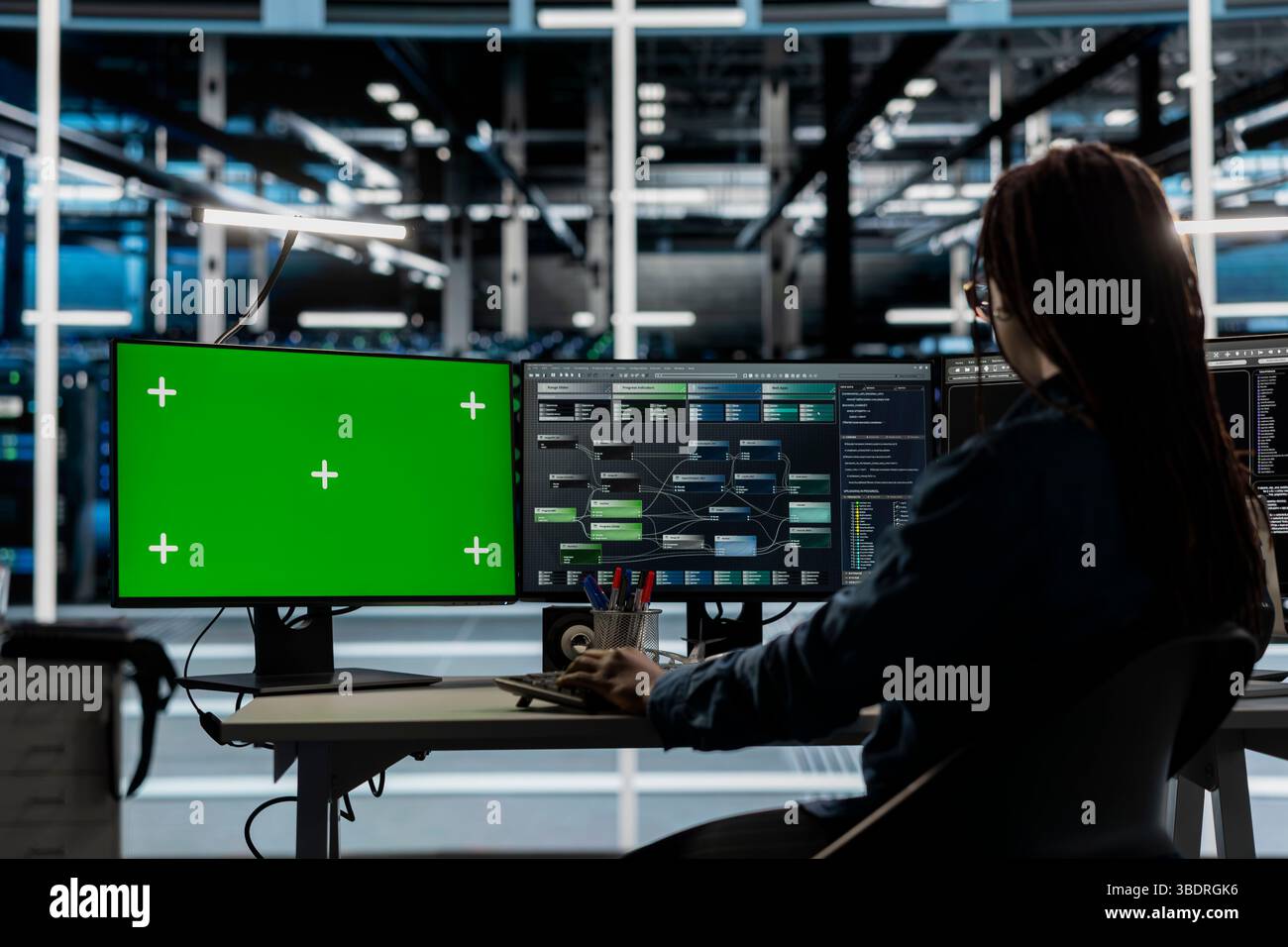 Server room technician using artificial intelligence tech on green screen PC to reduce downtime ...