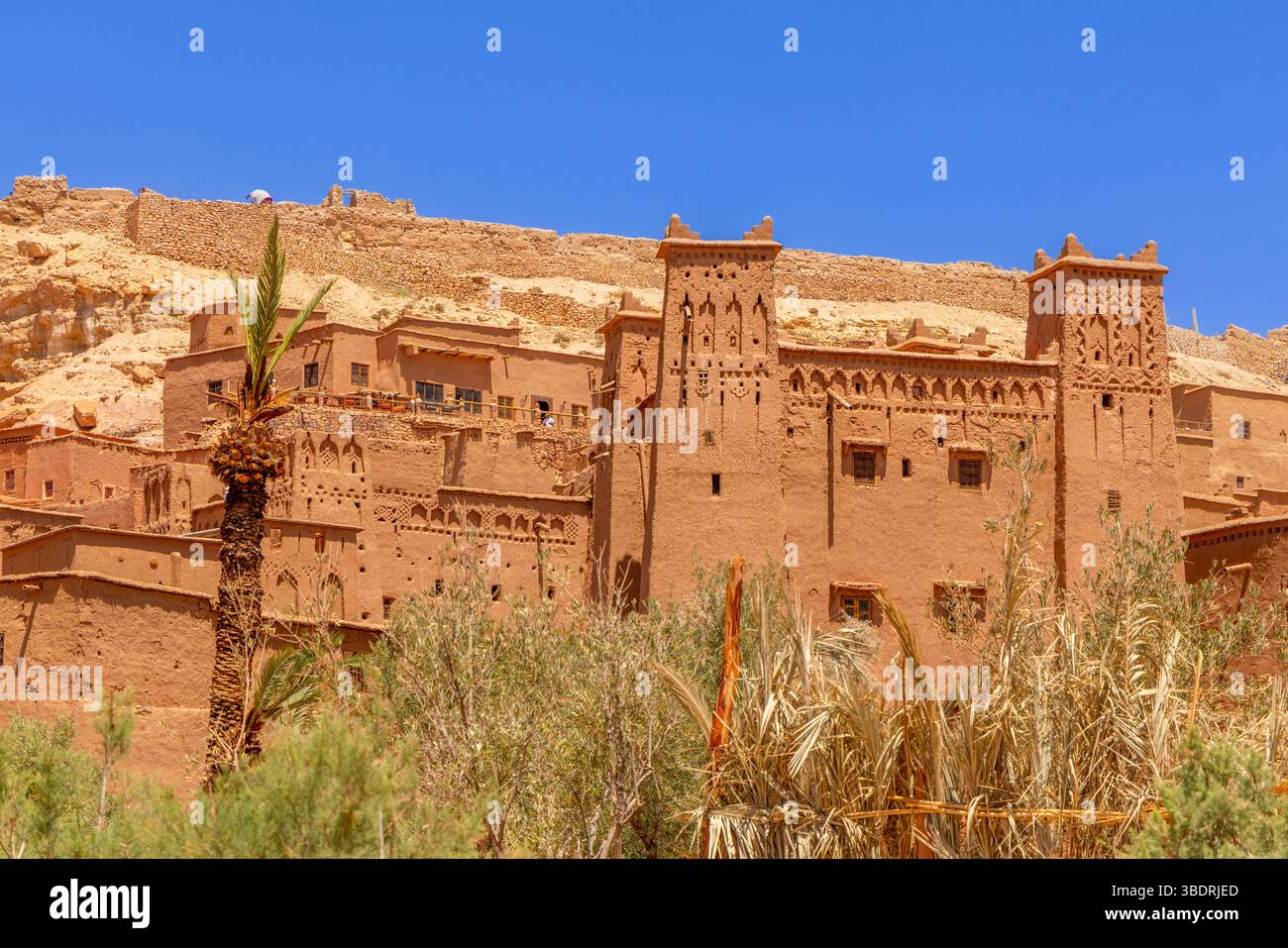 Ait Benhaddou ksar village walls and castle kasbah towers, with oasis ...