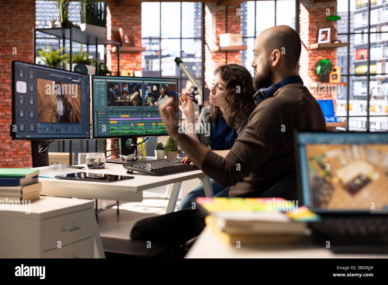 Video editors couple working as a team for a freelance video shoot ...