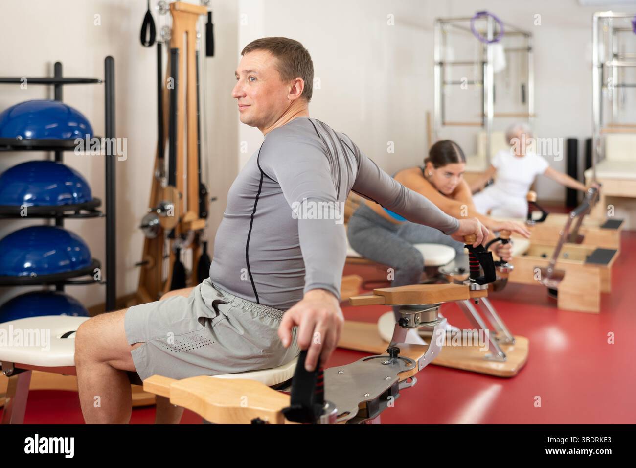 Man performs Pilates exercises for weight loss and toning muscles of ...