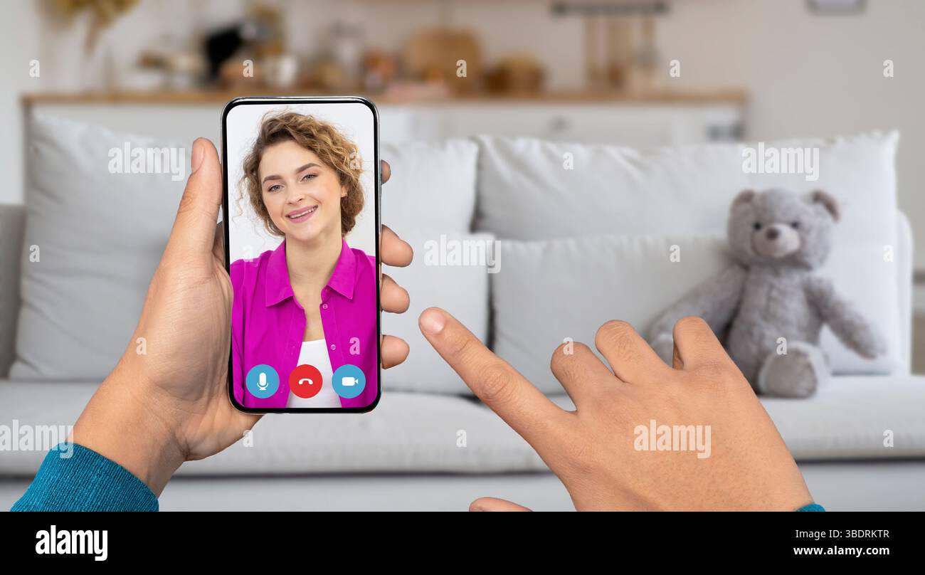 Connecting through a smartphone during a video call at home Stock Photo ...