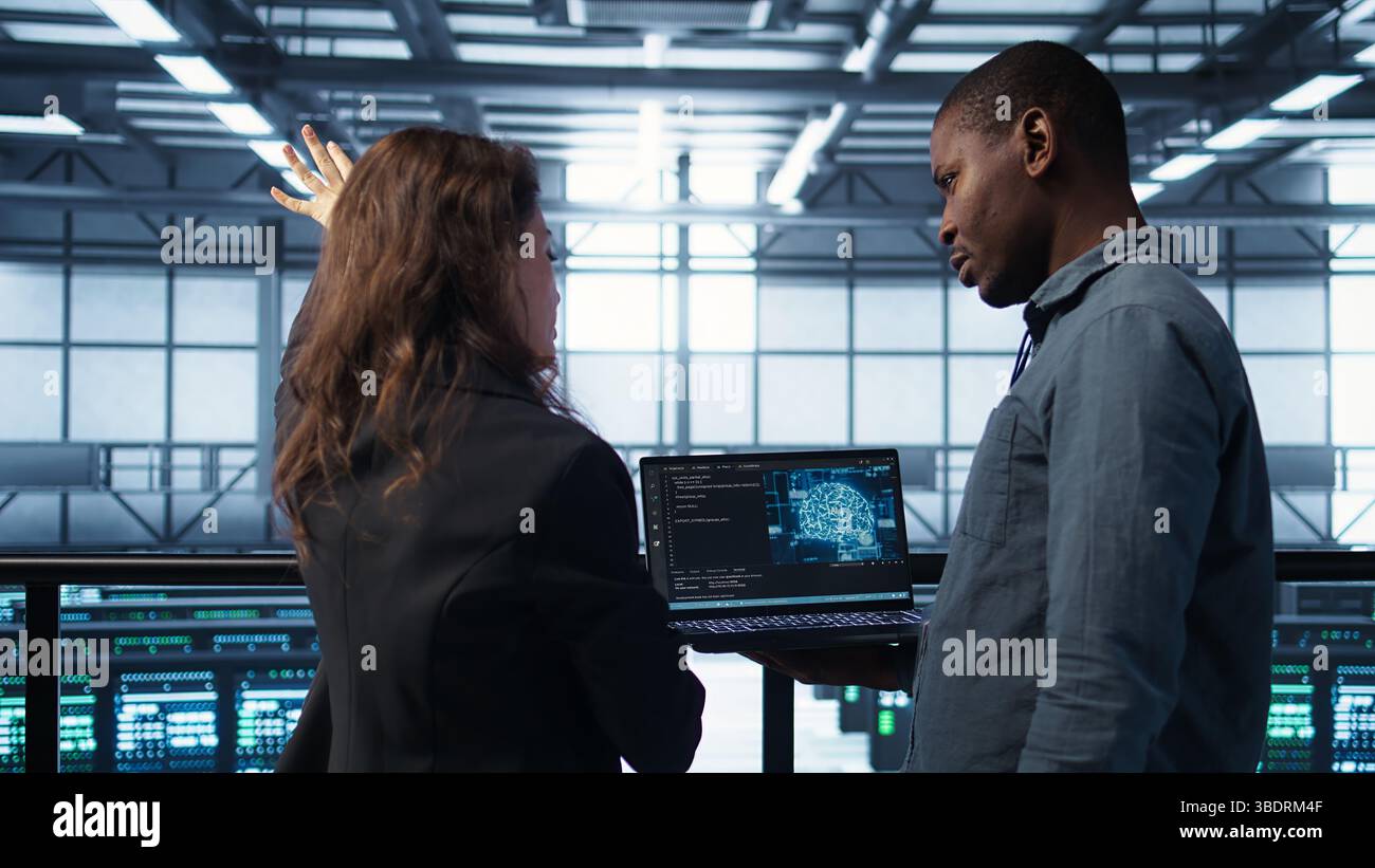 Software developers using AI tech on laptop in data center managing ...