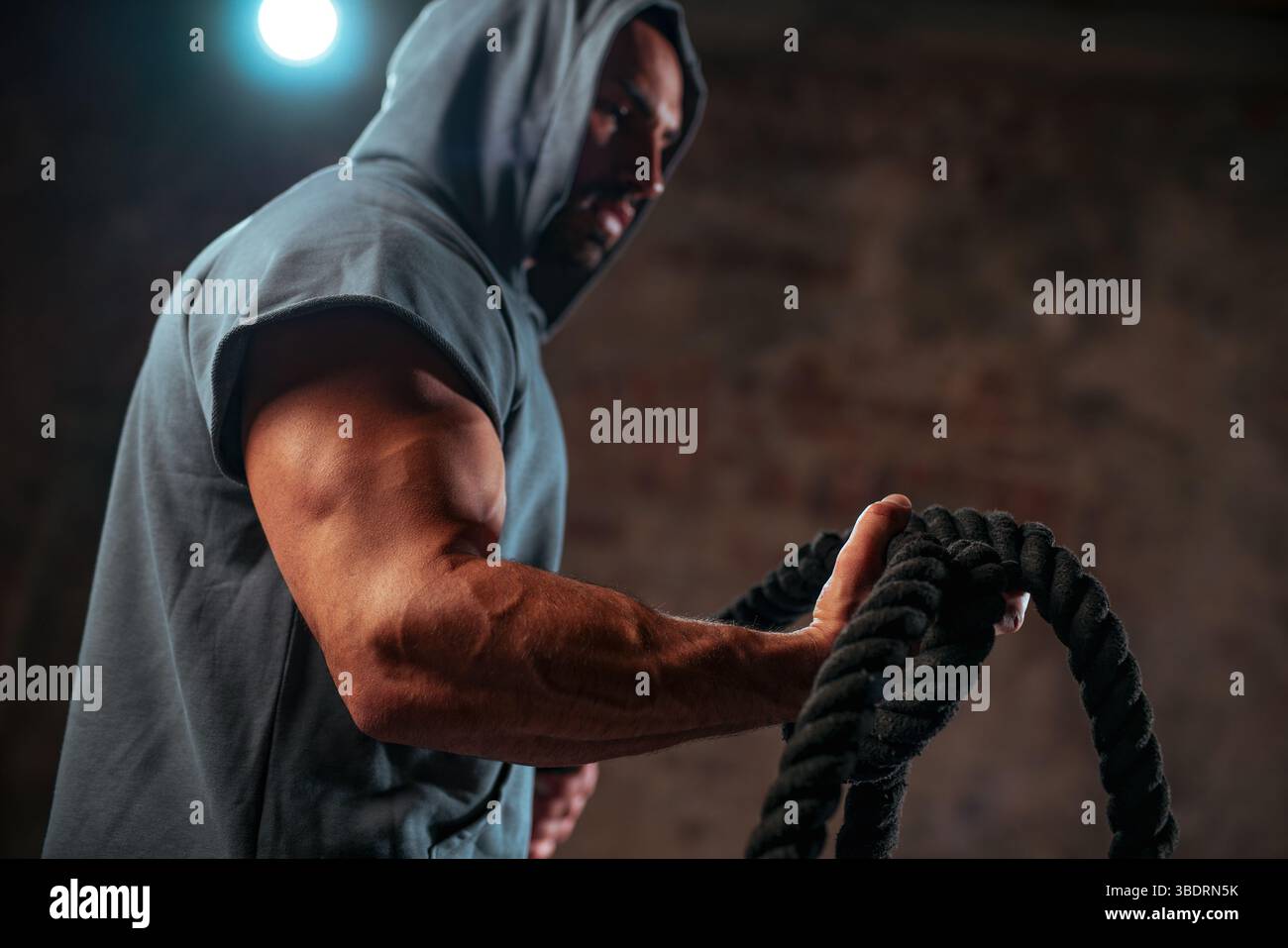 Strong man bodybuilder holds the rope Stock Photo - Alamy