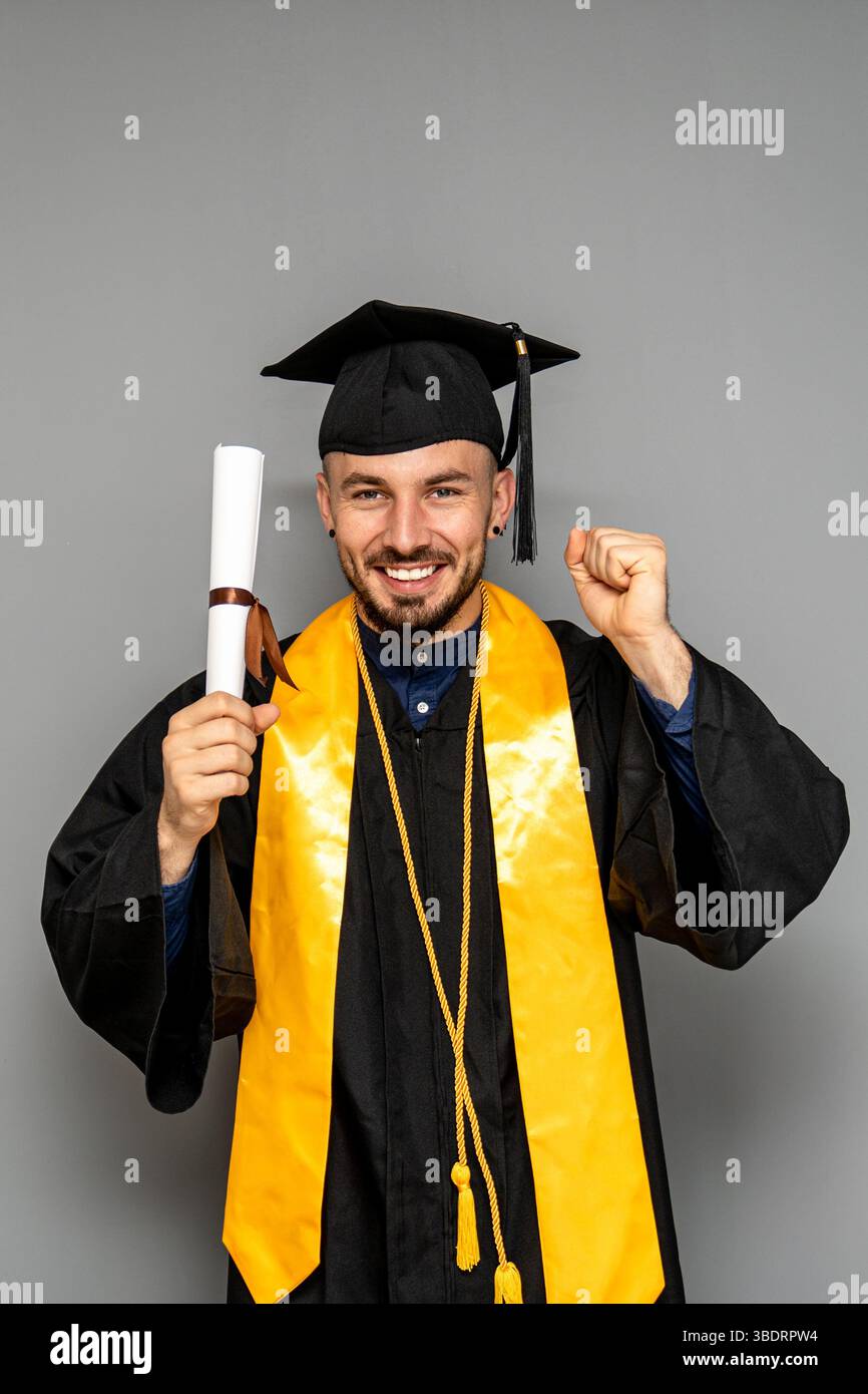 Happy graduated engineer celebrating with diploma and mortarboard Stock ...