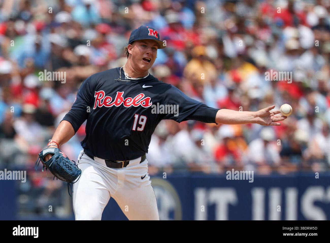HOOVER, AL - MAY 25: Ole Miss pitcher Walker Hooks (19) picks off a ...