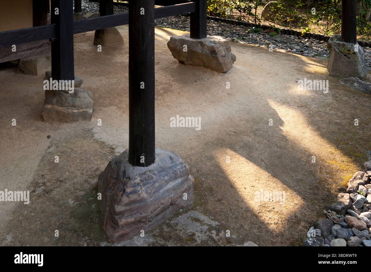 Natural stones provide the footing foundations for posts supporting a ...