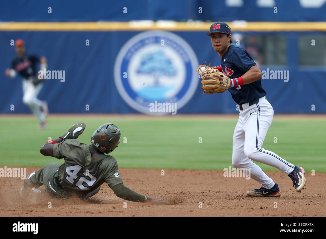 HOOVER, AL - MAY 25: Ole Miss infielder Luke Cheng (3) turns a double ...