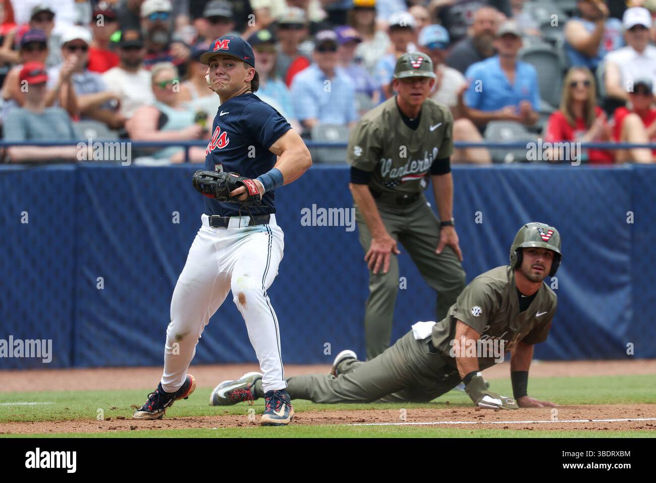 HOOVER, AL - MAY 25: Ole Miss infielder Luke Hill (7) fakes a throw to ...