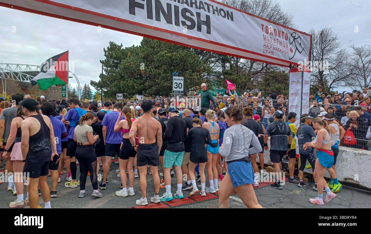 Toronto, ON, Canada - April 29, 2025: A large group of runners gathers ...