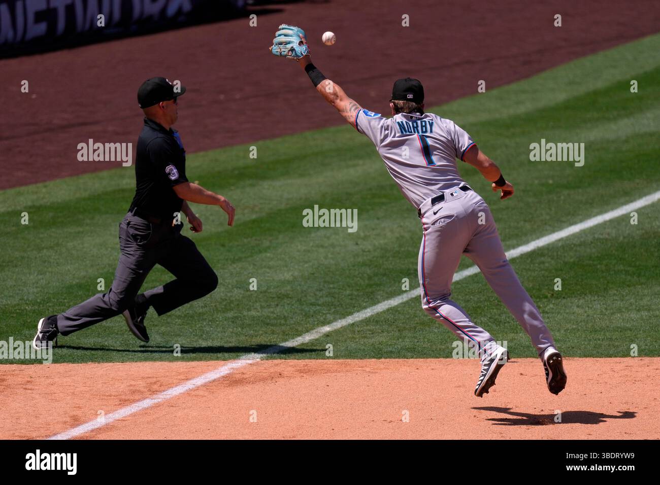 Miami Marlins third baseman Connor Norby reaches for a ball hit by Los ...