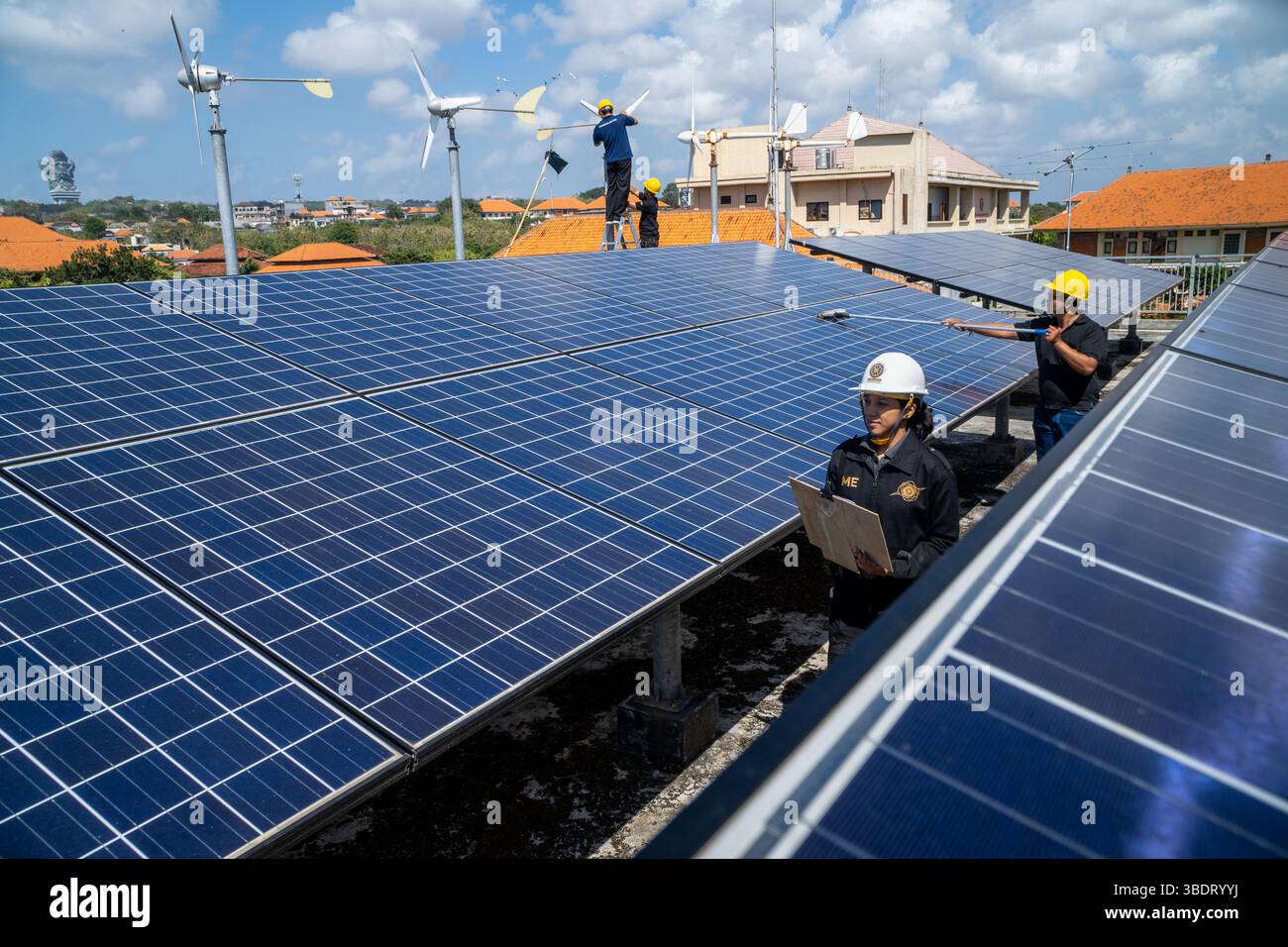 Denpasar, Bali: Aug 25 2023: Engineering students inspect and maintain solar panels and wind ...