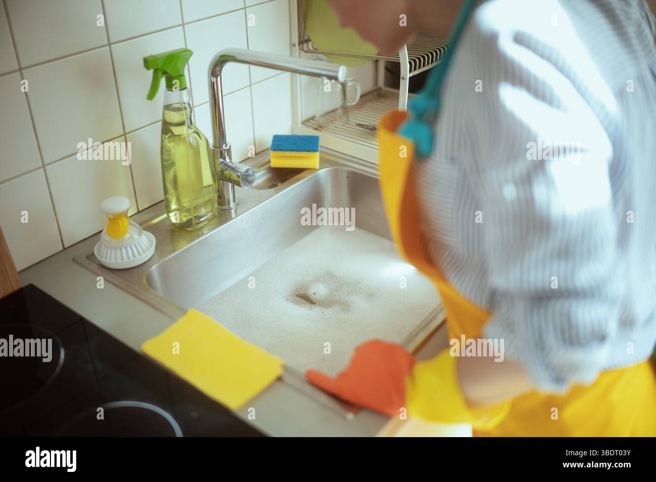 Woman cleaning kitchen leans hi-res stock photography and images - Alamy