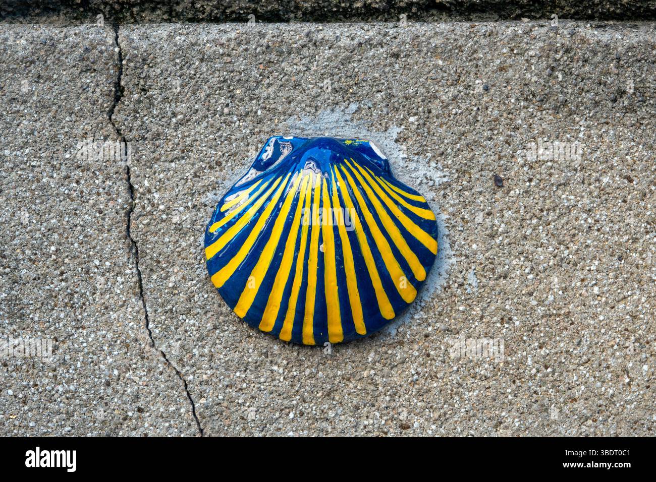 Milestone with yellow scallop sign pilgrimage to Santiago. Typical ...