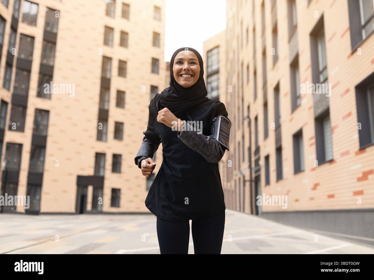 Sport For Muslim Women. Islamic Lady In Hijab Running On City Streets ...