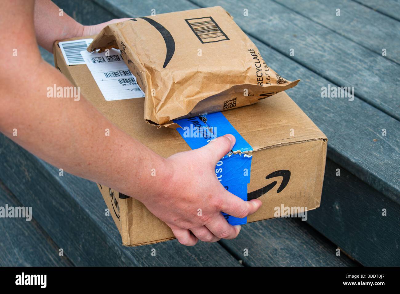 San Francisco, CA, USA – May 24, 2025: An Amazon delivery woman drops ...