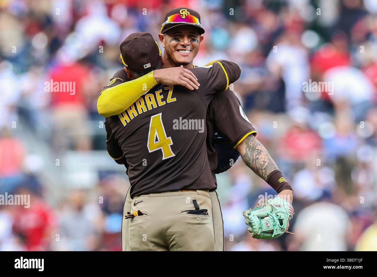 San Diego Padres first baseman Luis Arraez (4) hugs third baseman Manny ...
