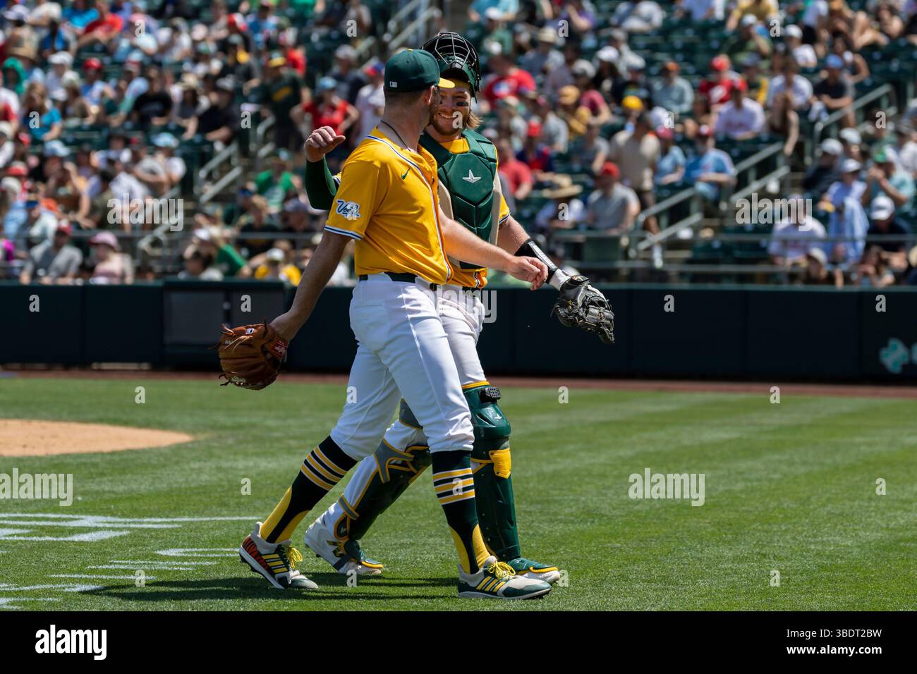 Athletics pitcher Hogan Harris, left, and catcher Willie MacIver, right ...