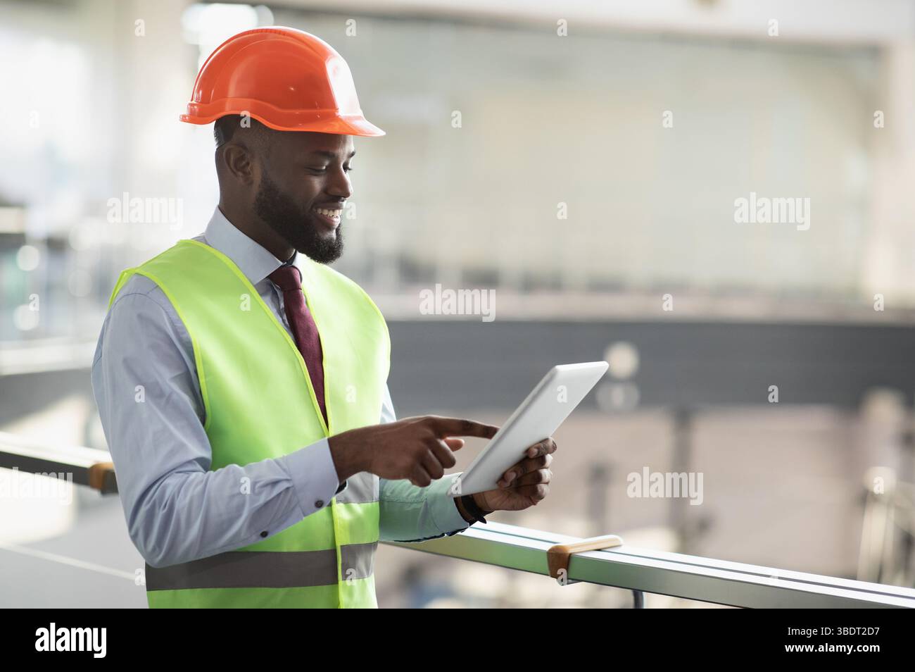 Smiling african american civil engineer with digital tablet, side view ...