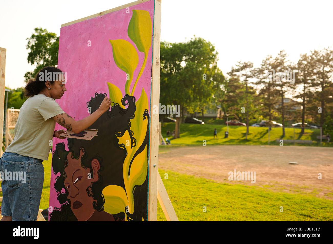Eva Ngono works on a painting in a park near George Floyd Square on the ...