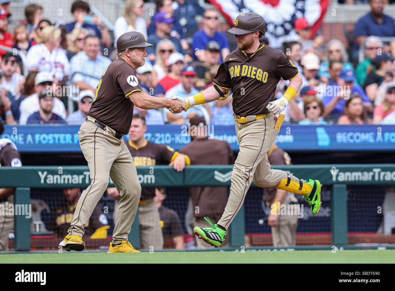 San Diego Padres' Jake Cronenworth high-fives third base coach Tim ...