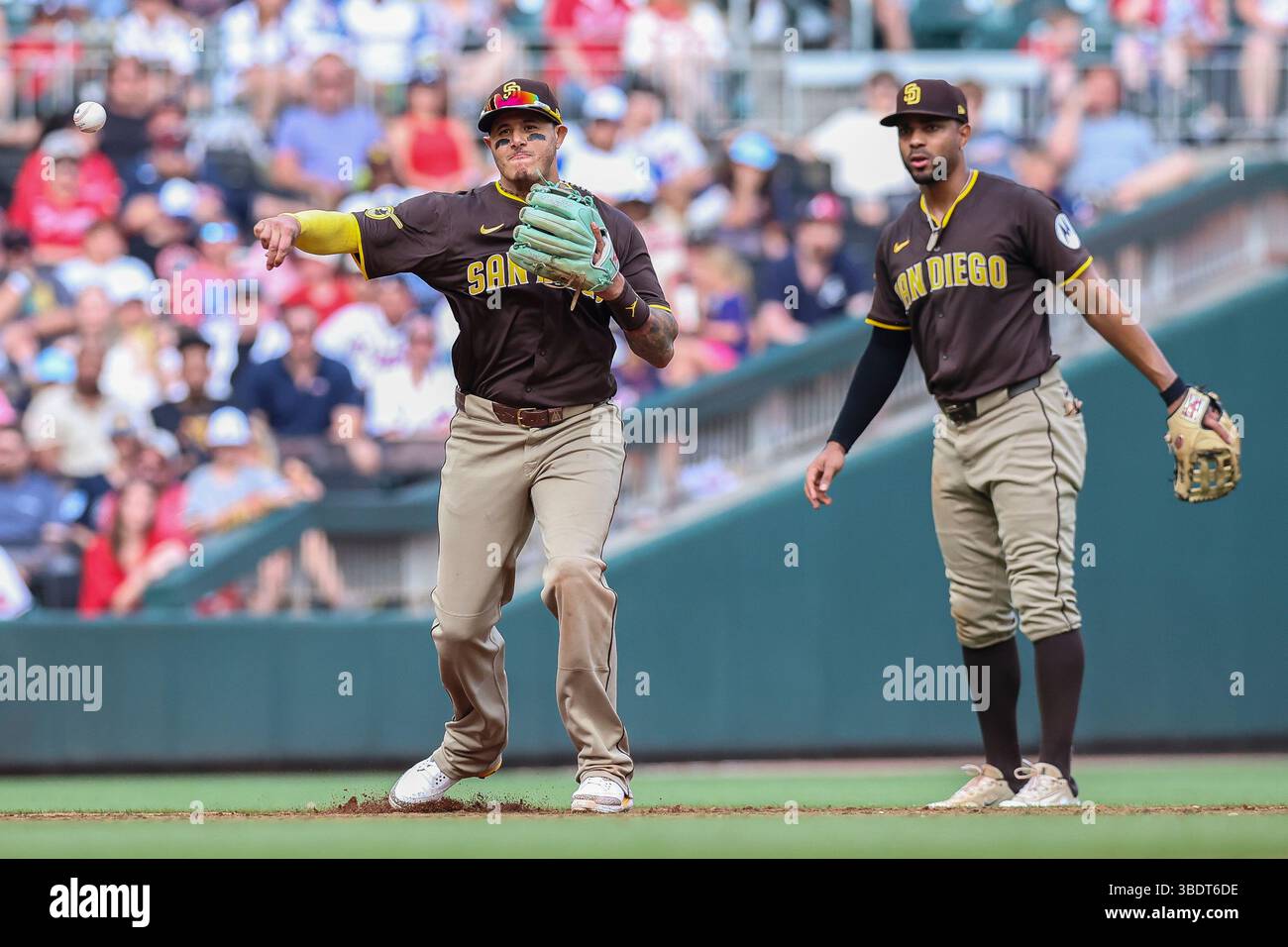 San Diego Padres third baseman Manny Machado, left, throws to first ...