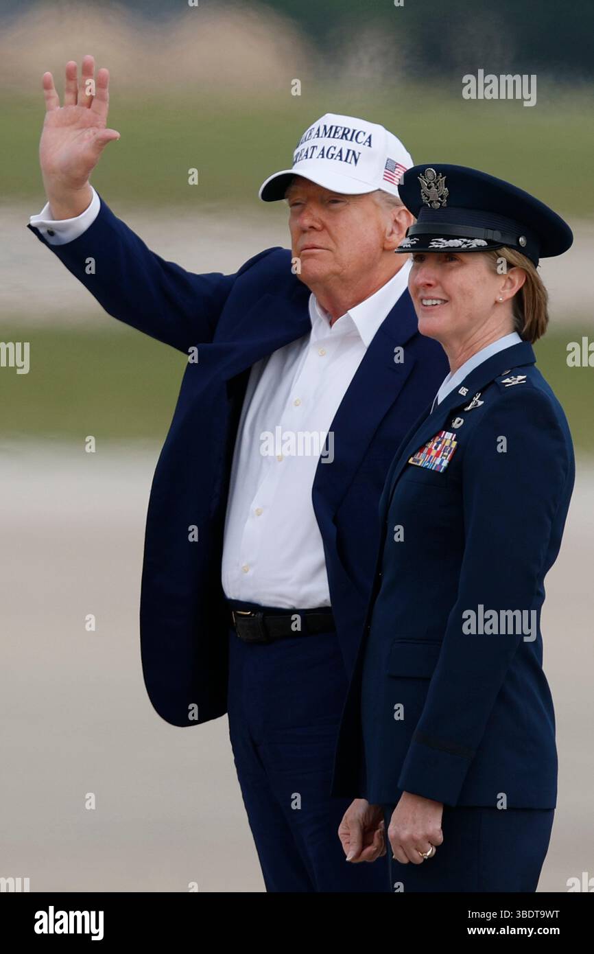 President Donald Trump waves as he is escorted by Air Force Col. Angela ...