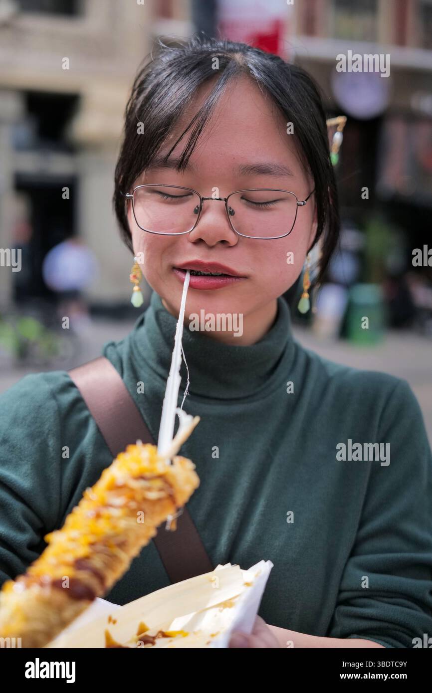 New York, New York, USA. 25th May, 2025. Eating traditional food at the ...