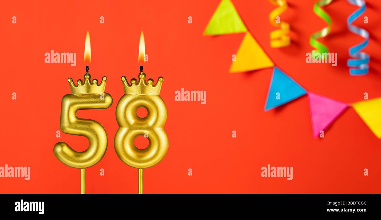 Number 58 candle - Birthday celebration on an orange background with ...