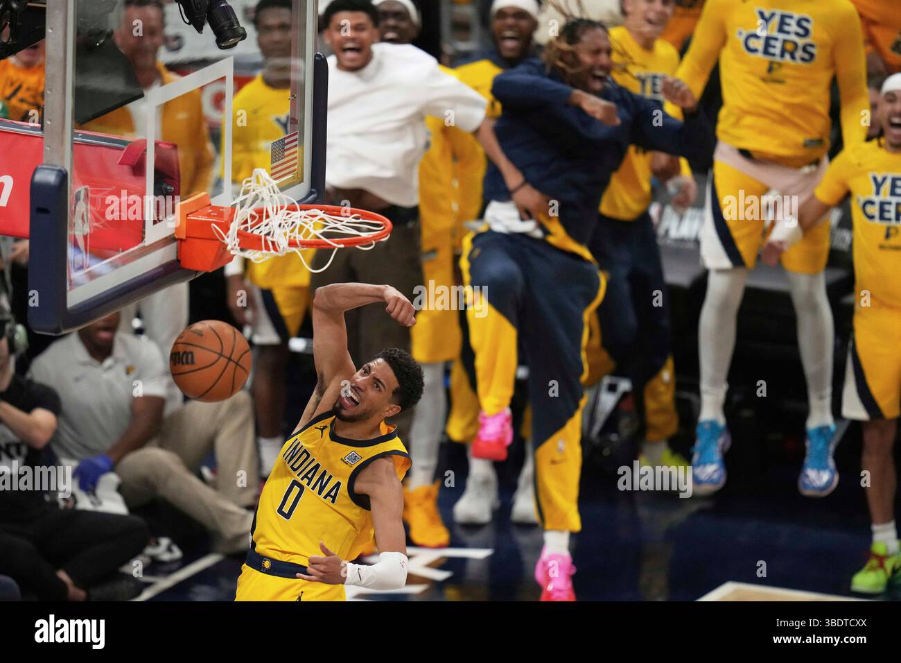 Indiana Pacers guard Tyrese Haliburton (0) dunks as teammates cheer ...
