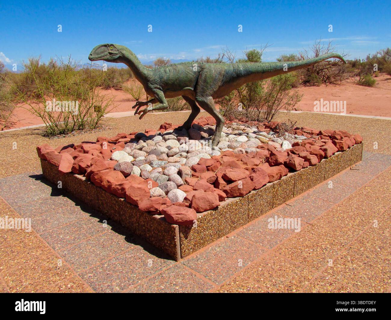 Dinosaurs in desert land. The statue, a model dinosaur standing on a ...