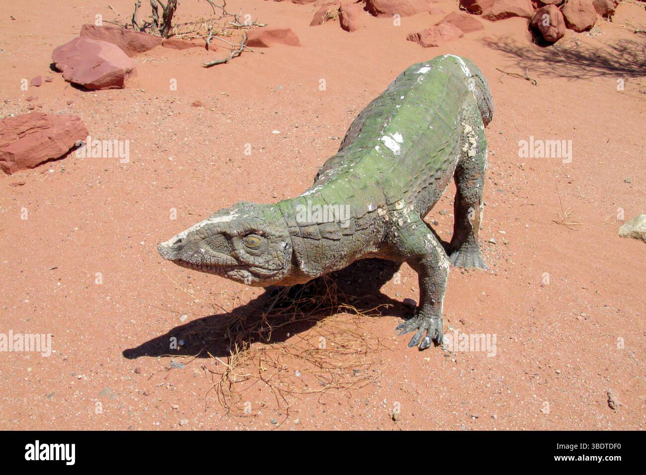 Dinosaurs in desert land. The statue, a model dinosaur standing on a ...