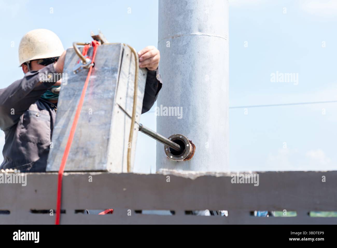 Environment officer install a monitoring on the boiler stack ...