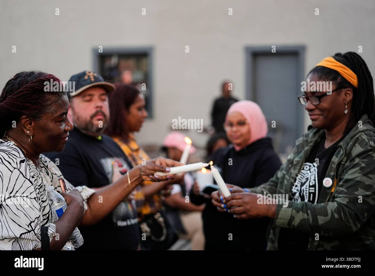 People light candles before a candlelight vigil at George Floyd Square ...